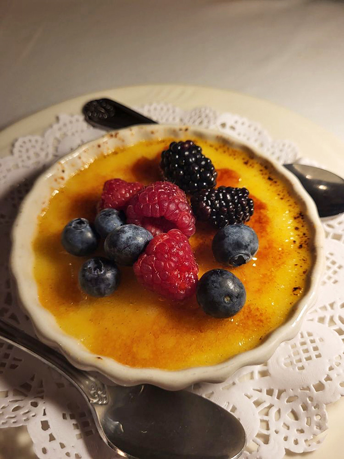 This crème brûlée's crackling top gives way to silky custard beneath—the dessert equivalent of discovering your hotel room got upgraded.