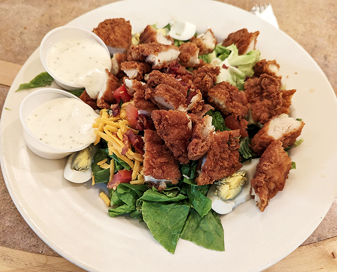 The crispy chicken salad performs that rare culinary magic trick: making you feel virtuous and indulgent simultaneously, with golden-fried chicken perched atop fresh greens.