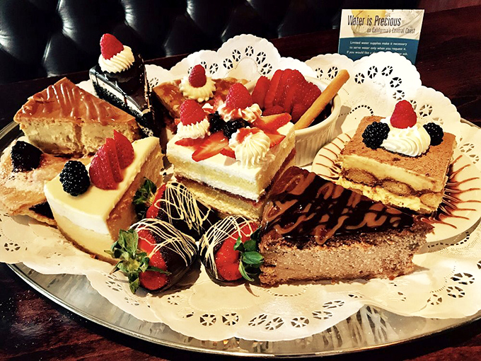 The dessert platter arrives like a sweet fever dream&mdash;a parade of cakes, tarts, and chocolate-dipped strawberries that makes sharing both necessary and slightly heartbreaking.