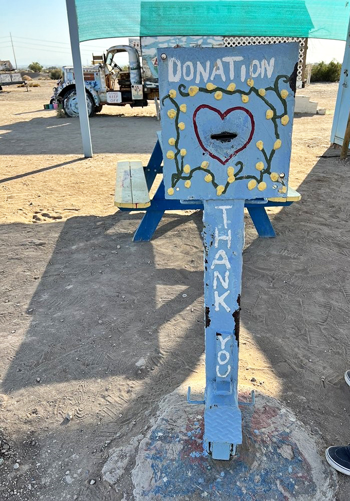 Even the donation box gets the full artistic treatment, its cheerful colors and hand-painted lettering embodying the homespun charm of the entire site.