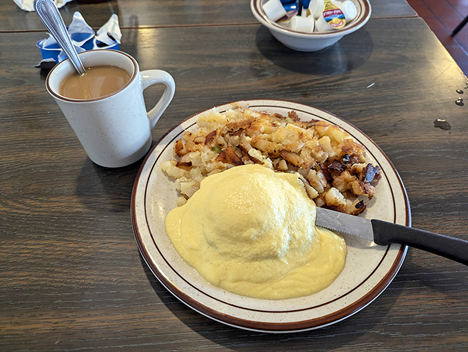 Hollandaise-draped perfection alongside crispy potatoes&mdash;proof that sometimes the best things in life come on a simple white plate with a brown rim.