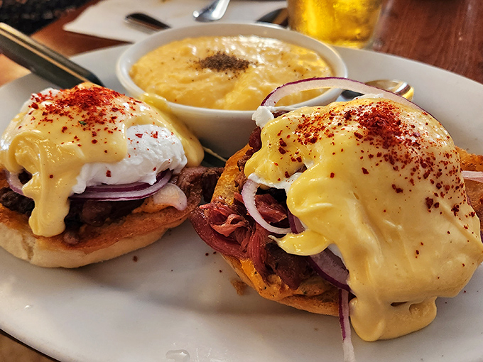 Eggs Benedict gets the Southern treatment with perfectly poached eggs draped in hollandaise that cascades like a golden waterfall over savory delights below.