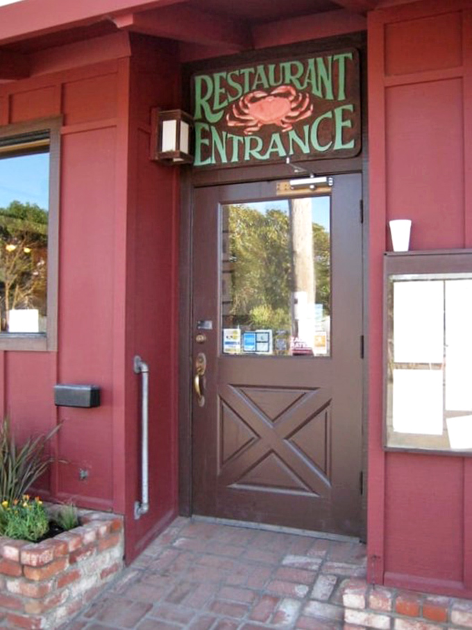 The entrance sign featuring a crab announces exactly what you're in for&mdash;coastal comfort that's been perfected since long before "farm-to-table" was trendy.