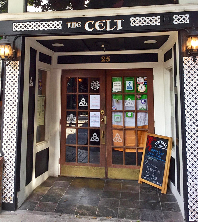 The Celtic knotwork framing the entrance isn't just decoration – it's a promise of the authentic Irish experience waiting just beyond those wooden doors.
