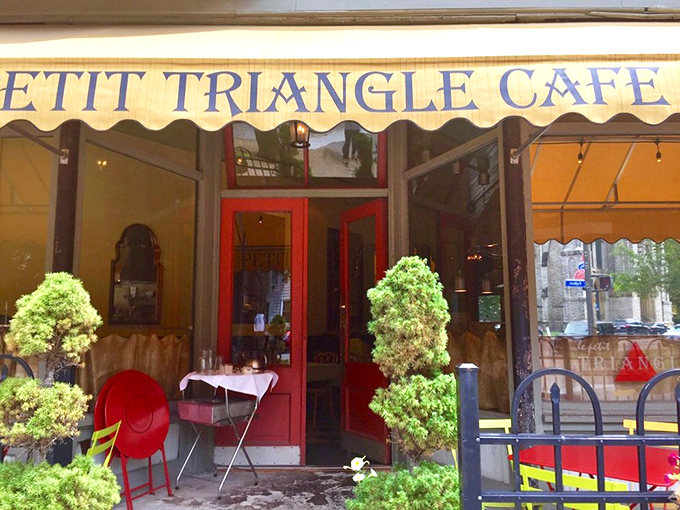 The red door stands like a portal to another continent. Those topiary sentinels have seen countless hungry arrivals and satisfied departures.