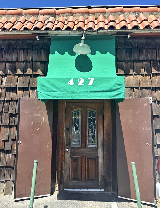 The green awning and wooden door serve as a portal to flavor country. This entrance has welcomed food pilgrims seeking Sacramento's most famous steak sandwich for decades.