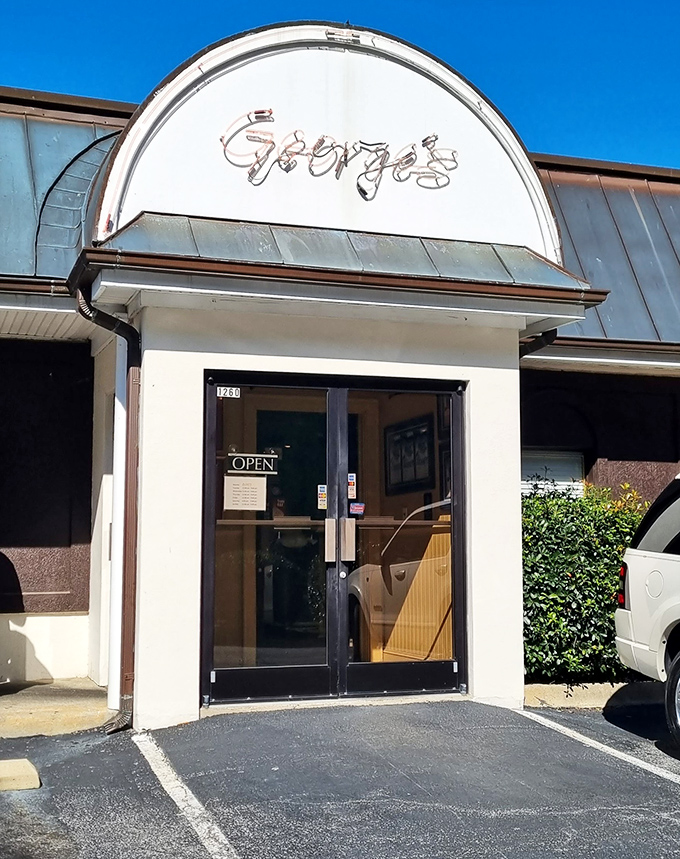 Bathed in sunlight, the entrance to George's looks like a portal to flavor town. That neon sign has guided hungry travelers for generations.
