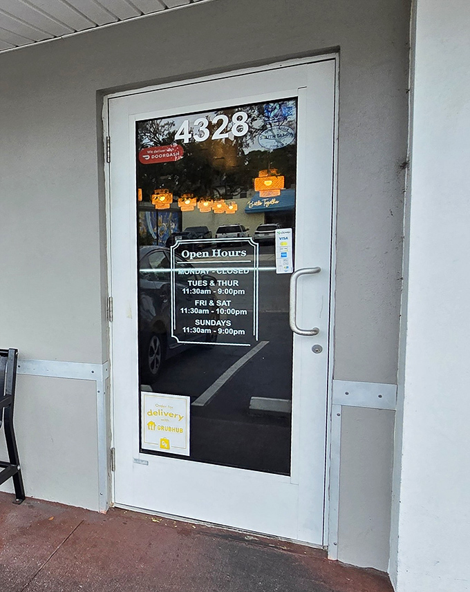 Business hours posted like an invitation to discover authentic flavors hiding in plain sight.