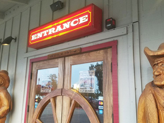 The entrance beckons with its neon glow and wagon wheel – a portal to a world where calories don't count and dinner is an event.