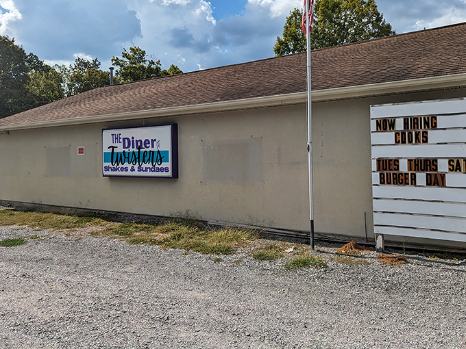 The side view reveals a humble establishment with a marquee announcing burger specials&mdash;a roadside beacon for comfort food seekers.