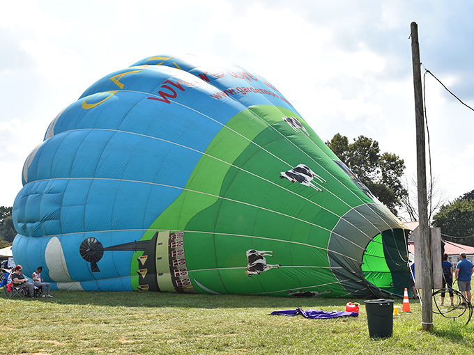 Hot air balloon preparations bring a splash of modern adventure to a landscape that typically celebrates the joys of staying grounded.