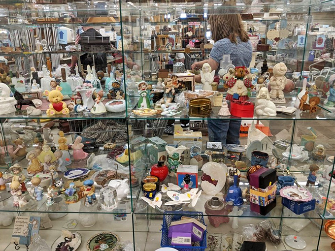Collectible chaos in the best possible way! Glass cases protect porcelain memories and childhood nostalgia just waiting for new homes.