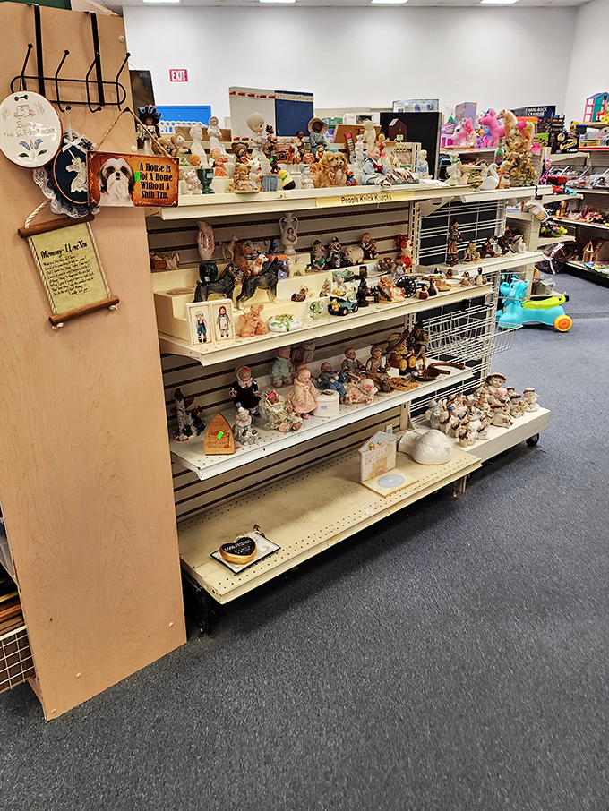 Figurine forest where ceramic animals, dolls, and knickknacks create a charming miniature world. That dog statue is practically begging to guard someone's bookshelf.