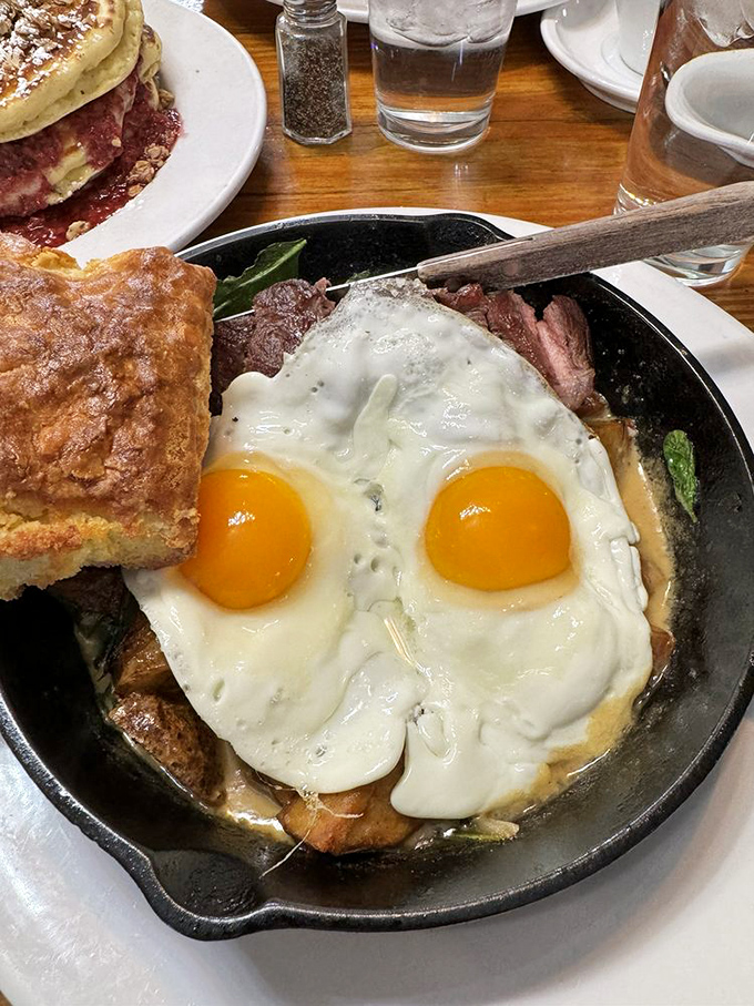 The skillet that answers all breakfast prayers &ndash; sunny eggs, savory steak, and that house-made biscuit ready to soak up every glorious bite.