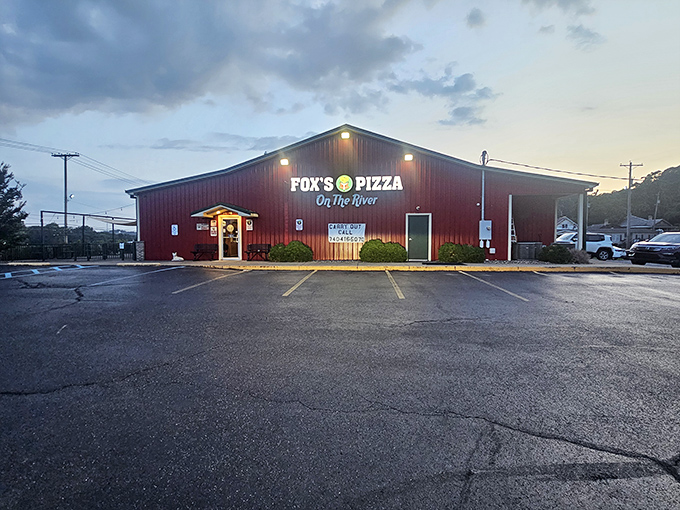 Fox's Pizza Den glows like a beacon at dusk, promising comfort food that satisfies both hunger and nostalgia in equal measure.