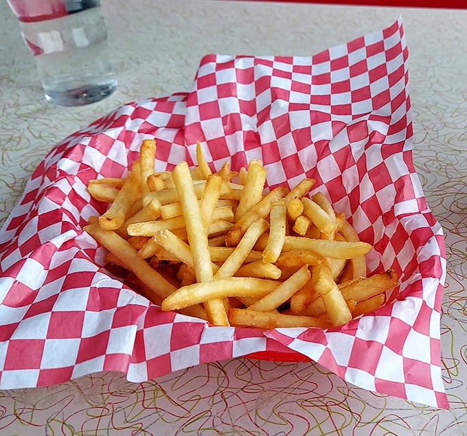 French fries served in checkered paper&mdash;a humble presentation for what might be the perfect supporting actor in the burger show.