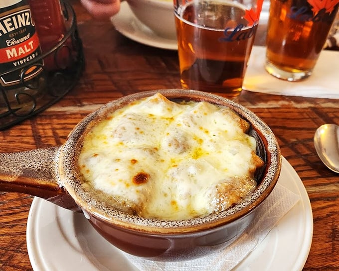 French onion soup that's worth the chin dribble and inevitable cheese pull. That golden crown of bubbling cheese is basically edible sunshine. 