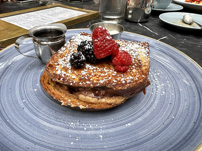 French toast that makes you understand why people wait in line for brunch. Topped with berries and powdered sugar, it's breakfast elevated to an art form.