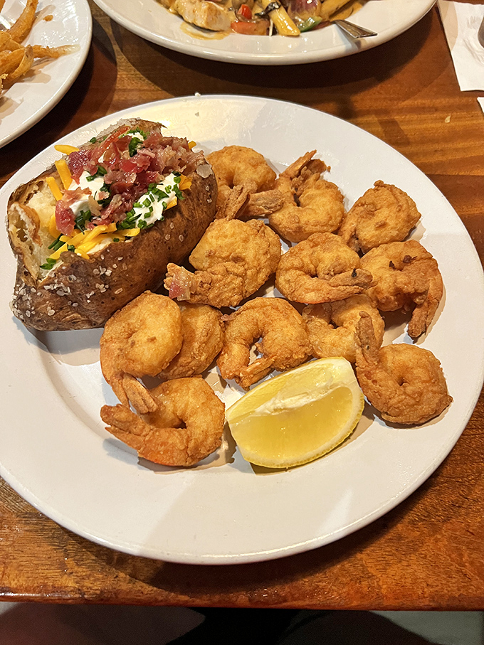 Golden-fried shrimp surrounding a loaded baked potato—a plate that answers "yes" to the eternal question: "Can I have it all?"