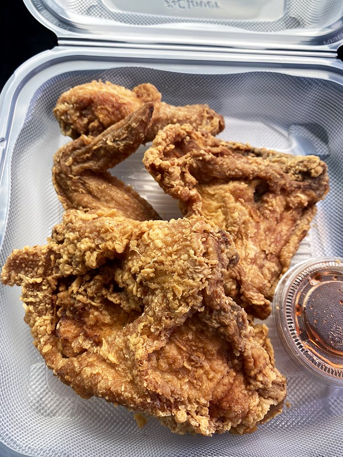 Fried chicken perfection to-go. Golden, crunchy coating protecting juicy meat within&mdash;proof that some of life's greatest pleasures come in styrofoam containers.