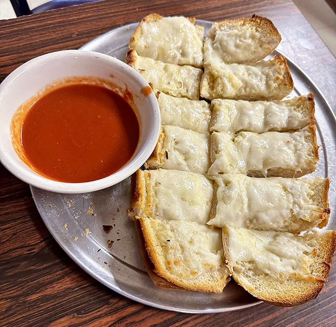 Garlic bread with cheese&mdash;the unsung hero of Italian-American menus. Simple, perfect, and somehow always exactly what you needed all along.