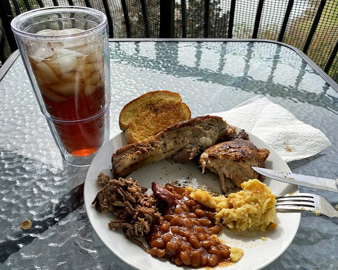 The sampler plate that solves decision paralysis. Ribs, pulled pork, beans, and cornbread—it's like the greatest hits album of Southern comfort food.