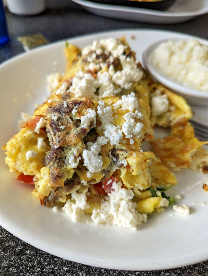 This Greek omelet doesn't just feed you—it hugs you from the inside, with feta cheese crumbles playing the role of confetti at this breakfast party.