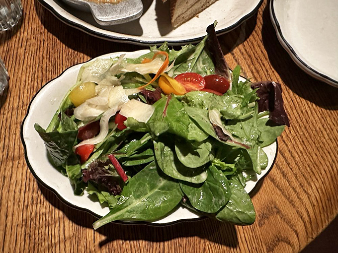 Even the green salad looks like it means business—a colorful assembly that reminds you vegetables can be more than just a guilt-appeasing afterthought.