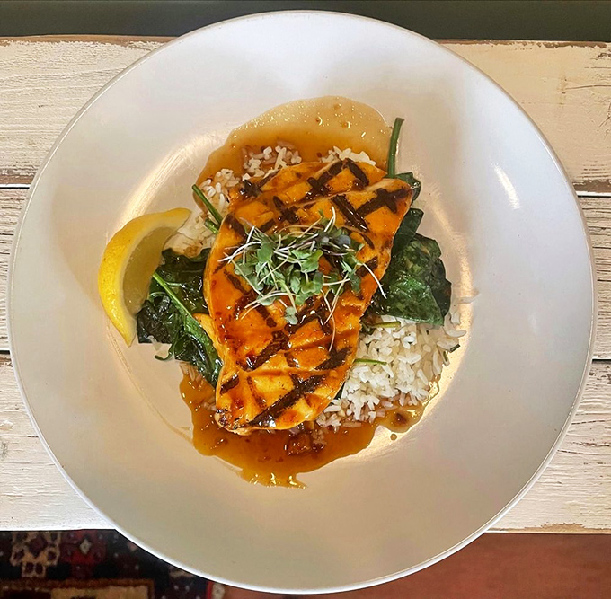 Grilled swordfish resting on a bed of rice and greens&mdash;the kind of simple, perfect plate that reminds you why humans invented cooking in the first place.