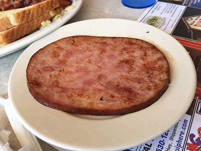 Ham sliced thick enough to make a statement on your plate. This isn't some paper-thin deli slice—it's a proper slab of pork that demands respect.