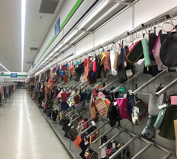 Purse paradise! Designer dreams and practical carryalls hanging in formation, ready to march home with you for a fraction of retail.