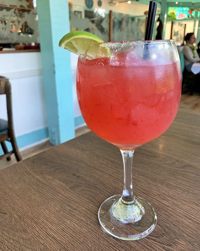 A vibrant hibiscus margarita that's basically vacation in a glass. The salt rim isn't just for show&mdash;it's the perfect counterpoint to the sweet-tart symphony.
