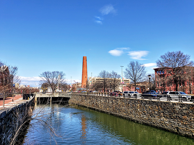 The Shot Tower stands majestically beside Jones Falls, its reflection dancing in the water like history rippling into the present.