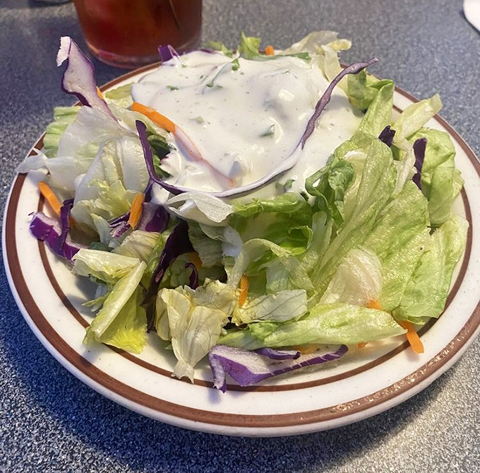 Even the salad has personality here&mdash;crisp, colorful, and topped with house-made dressing. A refreshing counterpoint to all that delicious diner decadence.