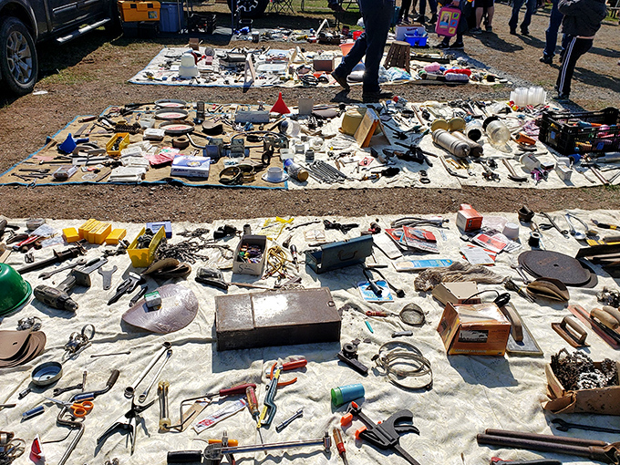The ultimate yard sale spread across tarps. Someone's "I don't need this anymore" becomes another's "I've been looking everywhere for this!"