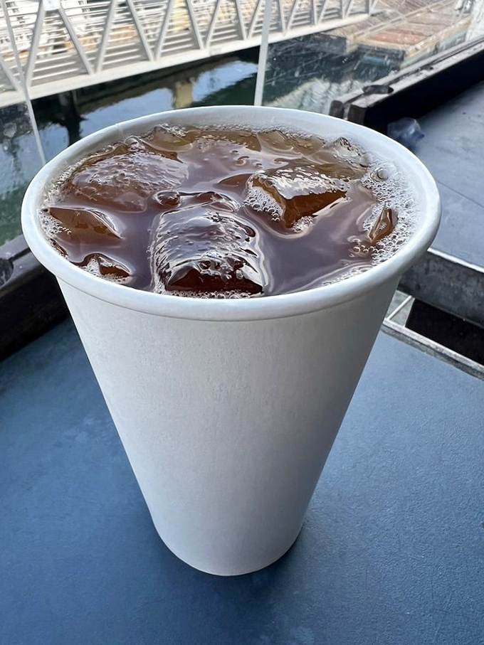 An iced drink with a view that makes you wonder why you ever waste time eating indoors. The harbor backdrop turns refreshment into an experience.