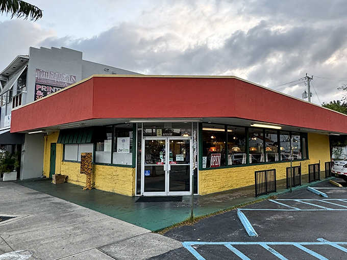 The corner entrance beckons like an old friend, its yellow and red exterior a cheerful landmark for hungry travelers on Biscayne Boulevard.