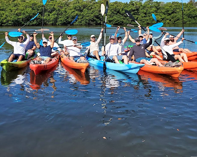 Adventurers glide through nature's tunnel, where every paddle stroke writes its own story.