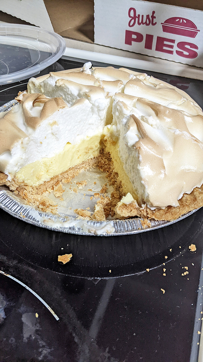 Key lime pie with a towering meringue crown. One slice missing because waiting for a photo was simply asking too much.