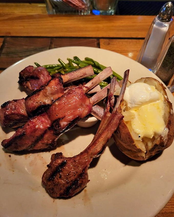 Lamb chops standing at attention like tiny meat lollipops. The perfect pink center proves that beef isn't the only game in town at Mountain Jack's. 