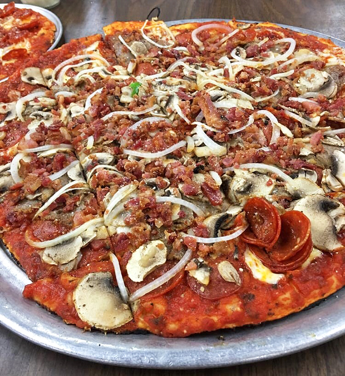 The supreme pizza&mdash;where every topping fights for your attention like siblings vying for the front seat, yet somehow creates perfect harmony in each bite.