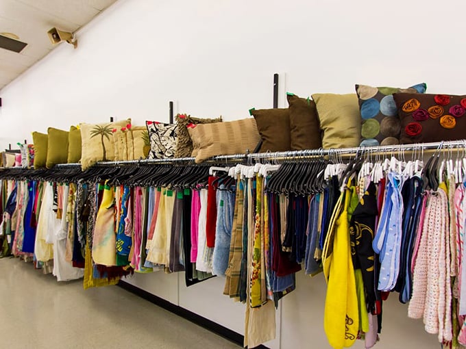 The textile treasure trove &ndash; where decorative pillows and summer dresses create an unexpected color story above the racks.