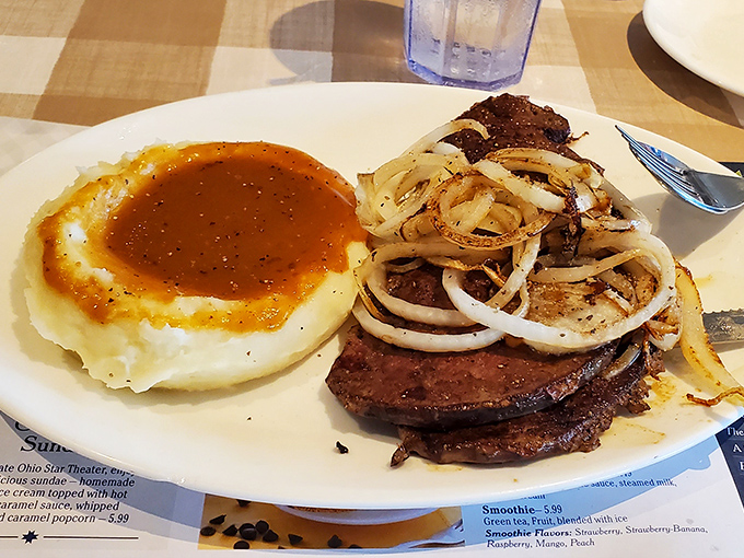 Liver and onions with mashed potatoes, proving comfort food classics never go out of style.