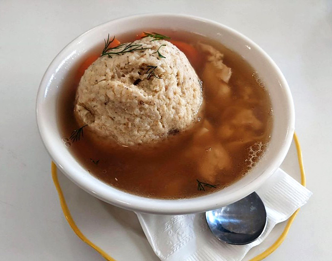 The matzo ball: perfectly buoyant, gloriously golden-surrounded. Floating in broth so clear you could read your fortune in it.