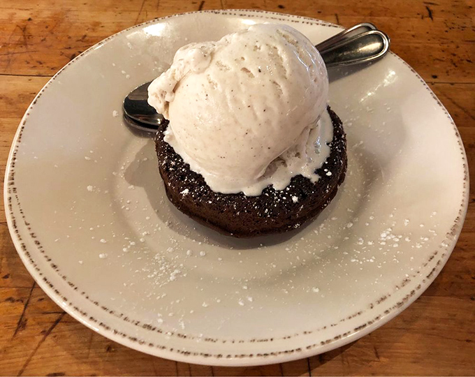 A warm chocolate cake that collapses under your spoon, releasing molten goodness that meets cold ice cream in a temperature tango of dessert perfection.