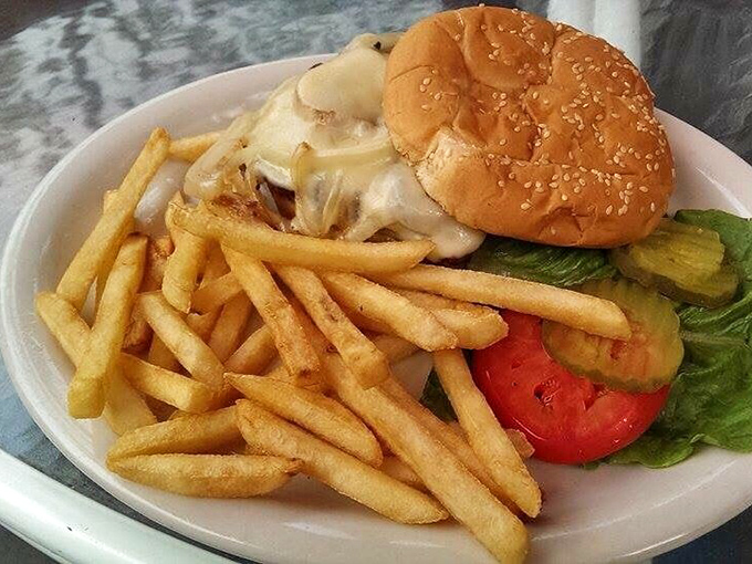 The burger that launched a thousand road trips—melted cheese cascading over a perfect patty with golden fries standing at attention. Worth every mile.