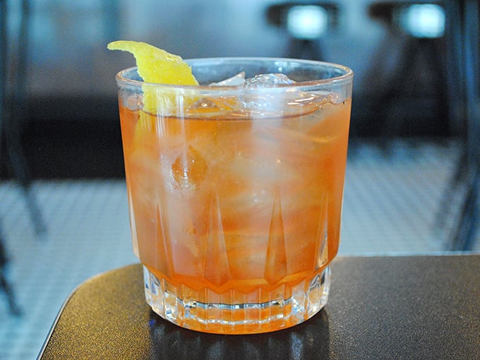 This isn't just an Old Fashioned—it's a time machine in a glass, with the perfect amber hue that whispers, "Slow down and savor me."
