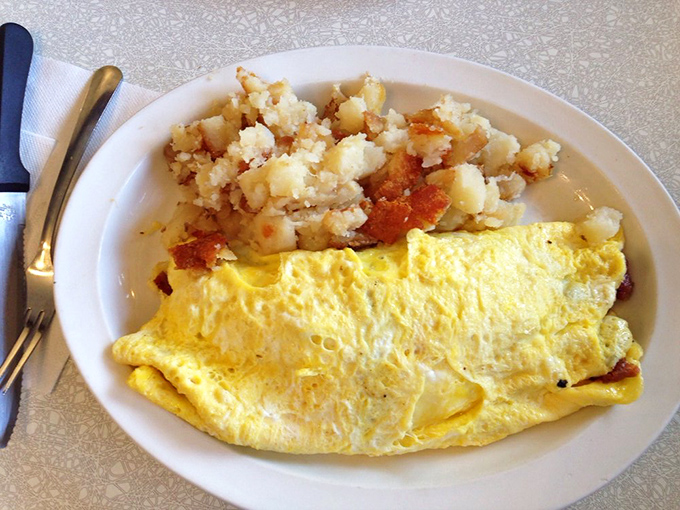 An omelet that puts hotel breakfast buffets to shame, with home fries that make you question why you ever bothered with fancy brunch spots.