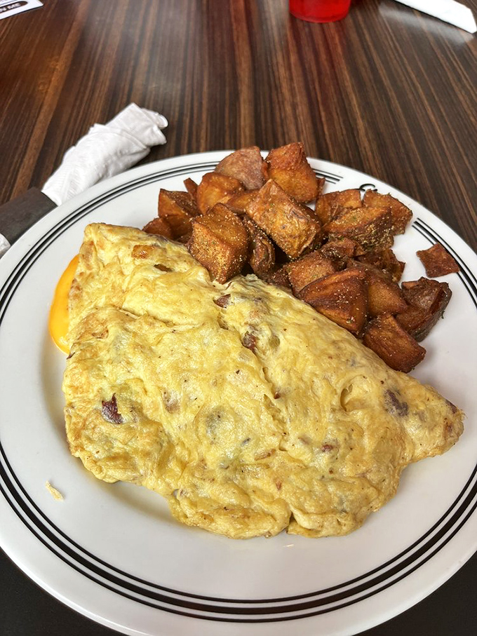 An omelet that's clearly been to the gym &ndash; muscular, well-defined, and impressive in size. Those potatoes didn't brown themselves into perfection.