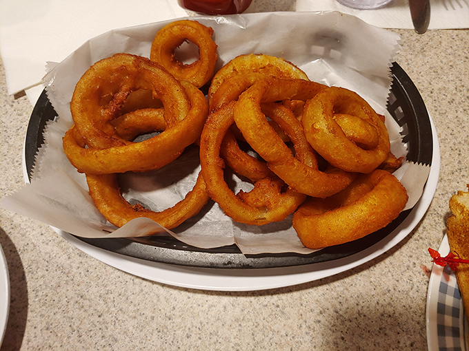These aren't just onion rings; they're golden halos of happiness&mdash;crispy, perfectly seasoned circles that make you wonder why you'd ever order anything else.